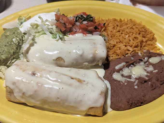 That white cheese sauce cascading over everything is basically edible happiness in liquid form.