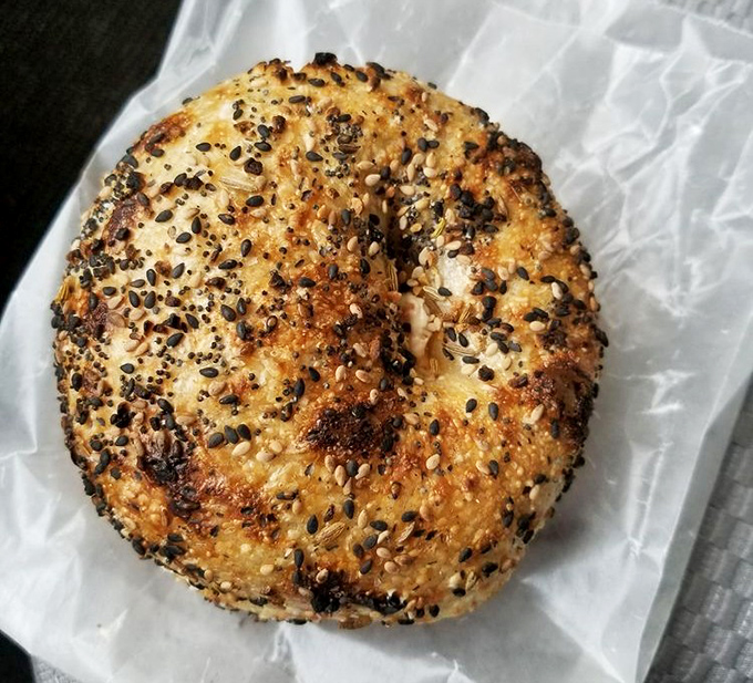 A symphony of seeds and seasonings atop a hand-rolled, wood-fired canvas &ndash; bagel perfection in its most elemental form.