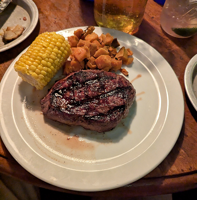 Tenderloin perfection on a plate – this steak cuts like butter and disappears just as quickly, accompanied by classic sides that complete the hearty meal.