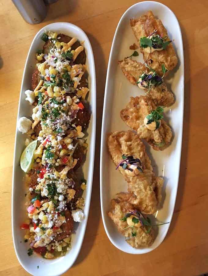 The fried green tomatoes share the spotlight with delicate squash blossoms, because why choose one vegetable when you can celebrate them all?