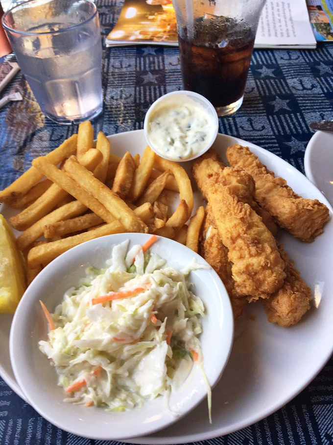 Golden-battered fish with crispy fries and tangy slaw &ndash; the holy trinity of seafood comfort that makes you want to hug the chef.