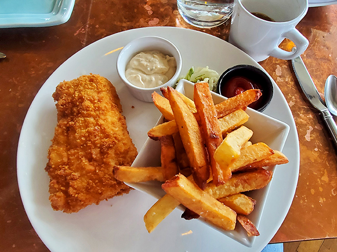 Golden-battered perfection meets hand-cut fries – this isn't just fish and chips, it's the coastal comfort food of your dreams.