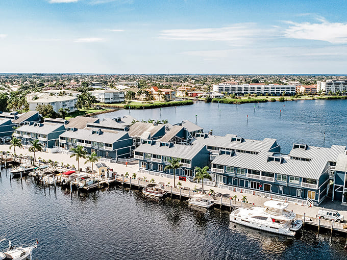 Fishermen's Village stretches into Charlotte Harbor like a welcoming hand, offering shopping, dining, and views that make smartphones temporarily irrelevant.