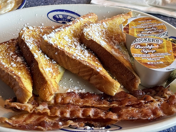 French toast dusted with powdered sugar like cosmic dust, accompanied by perfectly crisp bacon &ndash; breakfast that's worth crossing galaxies for.