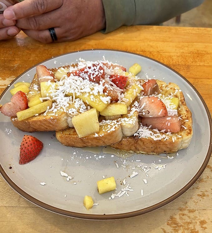 French Toast: Fruit-topped French toast that transforms ordinary bread into an extraordinary morning experience &ndash; breakfast alchemy at its finest.