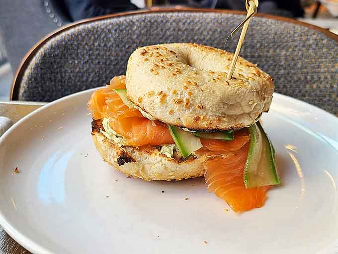 The gravlax bagel presents itself as a perfect circle of morning joy, salmon and avocado playing together like old friends.