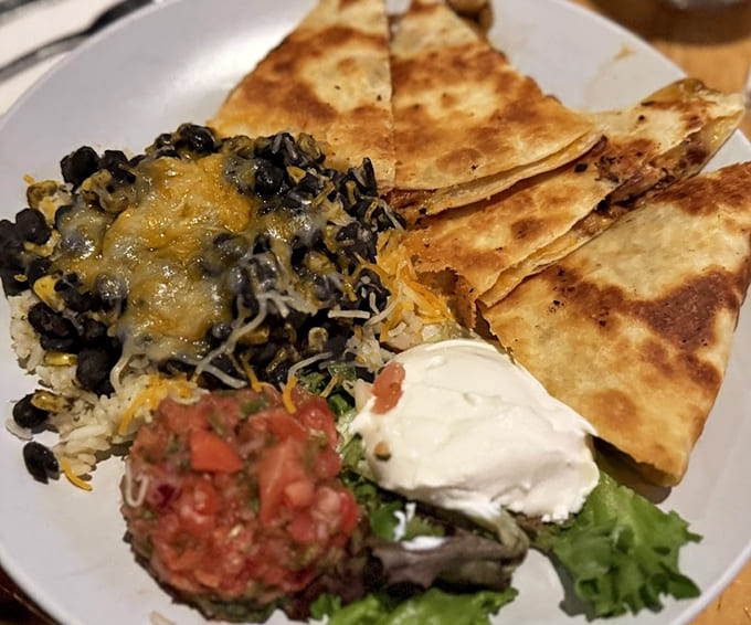 This loaded quesadilla plate with all the accompaniments shows why sharing appetizers is both generous and strategically smart for trying everything.
