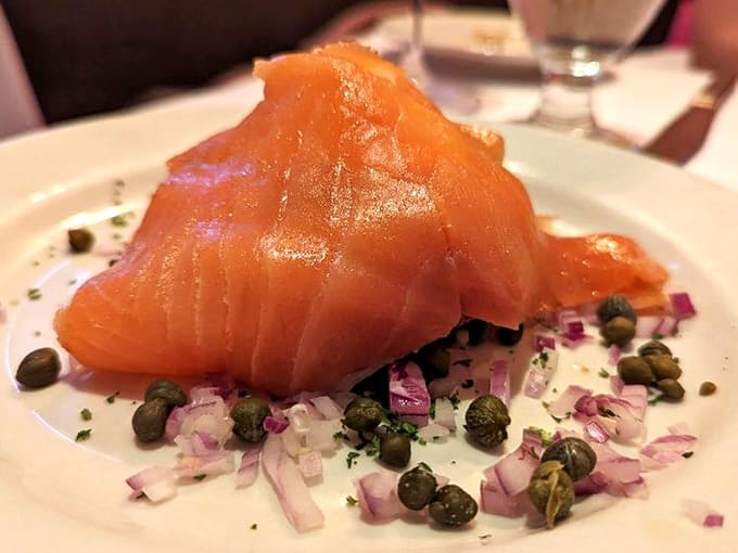 Smoked salmon gets the royal treatment here, artfully arranged with capers and red onion like edible jewelry on your plate.