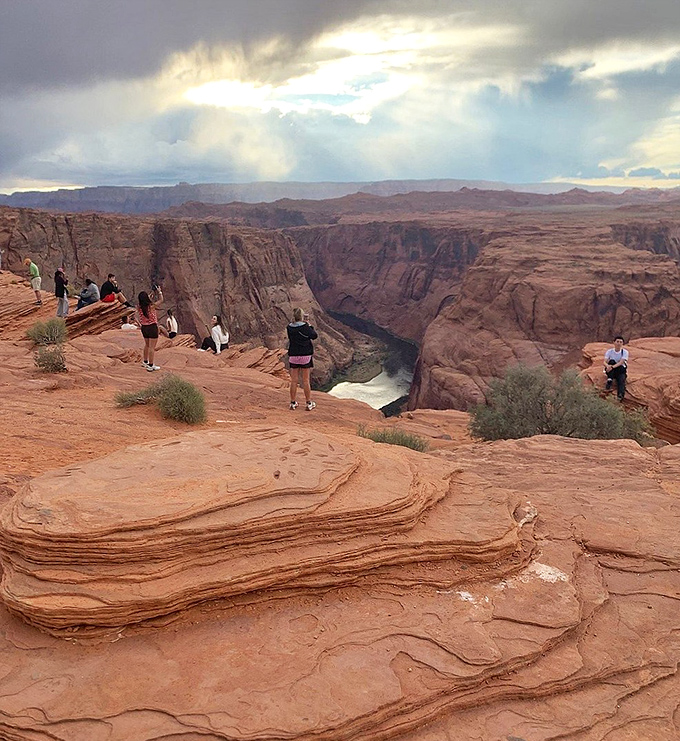Perched on the edge of magnificence, visitors experience the heart-stopping thrill of Horseshoe Bend's dramatic cliffside perspective.