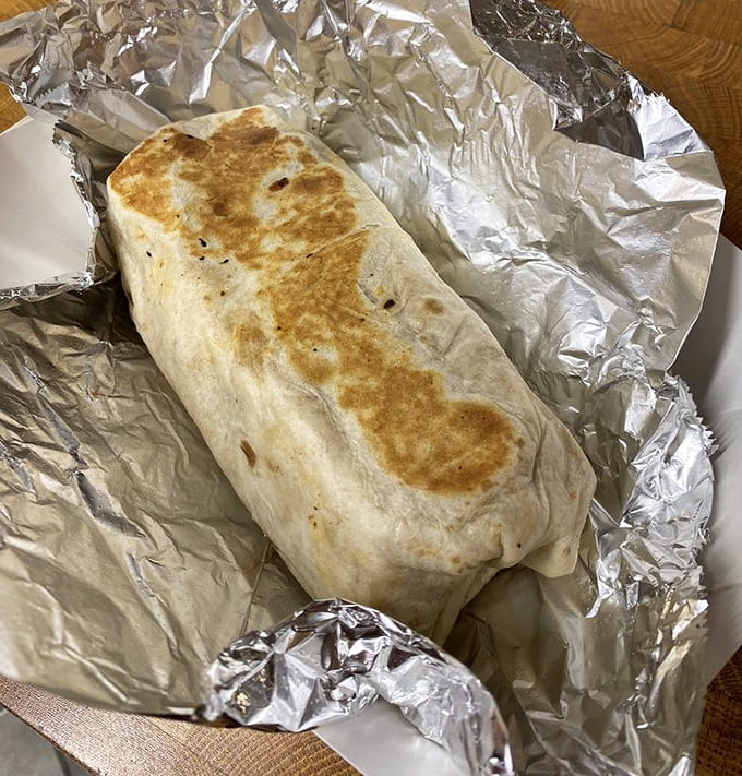 A burrito wrapped in foil promises portable deliciousness, perfect for taking your meal on a Lake Superior shoreline stroll.