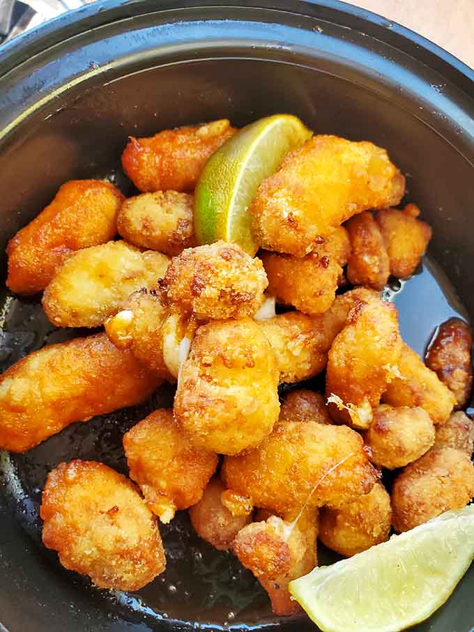 Nashville hot cheese curds bringing the heat and the gooey goodness, like tiny flavor bombs that explode with deliciousness in your mouth.