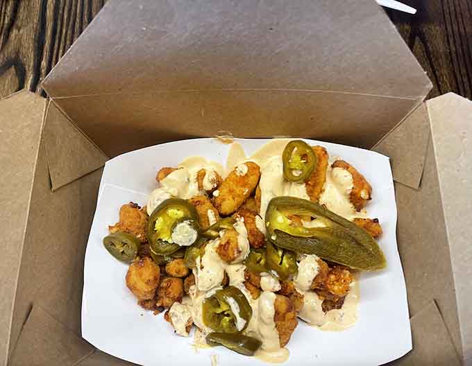 Even the to-go presentation looks appetizing, with foil-wrapped tacos ready for adventure and curds that travel well.