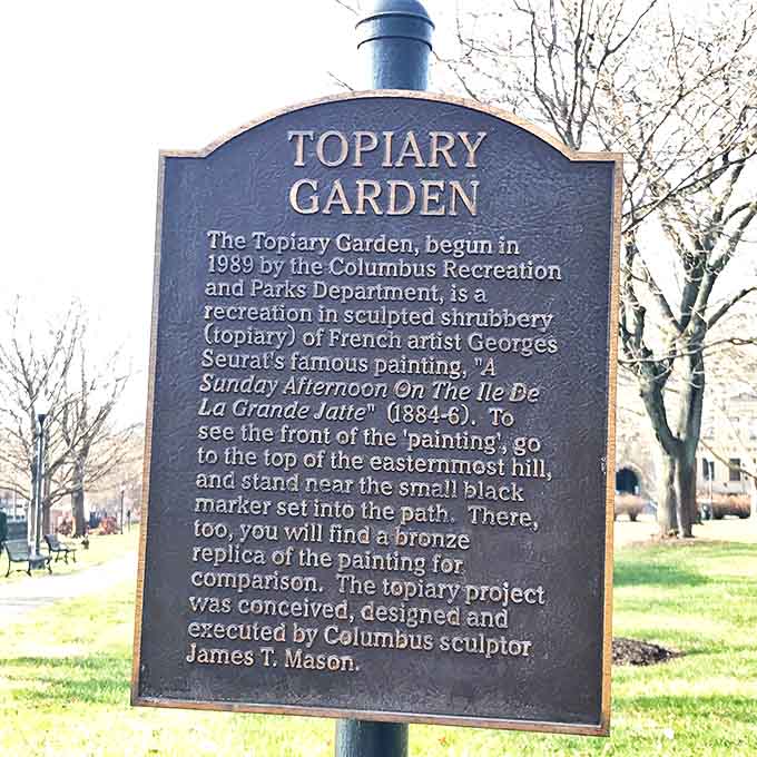 The garden's information board reveals its artistic secret – a living recreation of Seurat's famous painting through clever horticulture.