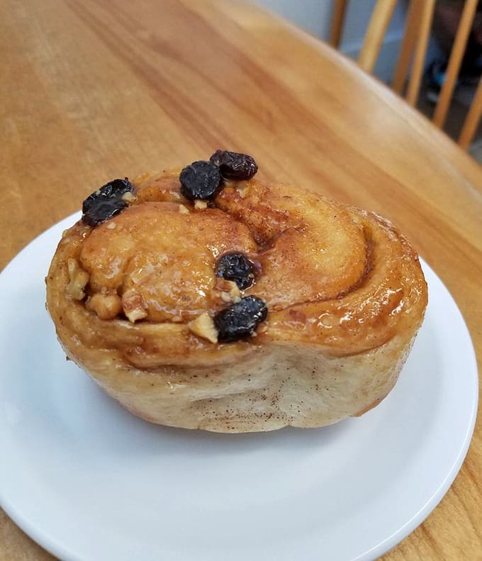 The sticky bun glistening with caramelized sugar and studded with nuts is basically edible happiness on a plate.