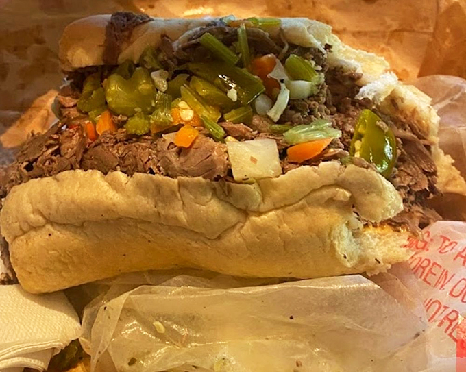 Prepare for a flavor explosion! This Italian beef sandwich is so packed with goodness, it barely fits in the frame.