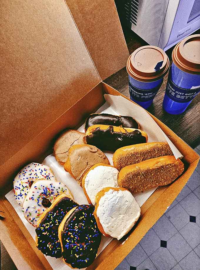 Coffee and donuts together in one box, proving that some partnerships are simply meant to be, like peanut butter and jelly or weekends and sleeping in.