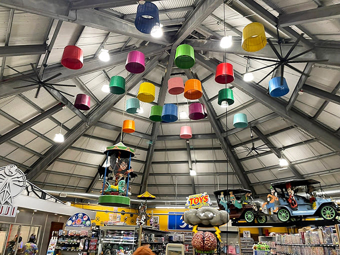 Colorful buckets dangle from the ceiling in patterns that make you wonder who greenlit this brilliance.