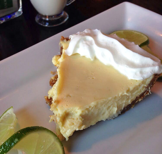 Key lime pie that strikes the perfect balance between sweet and tart, garnished with fresh lime slices and a cloud of whipped cream.