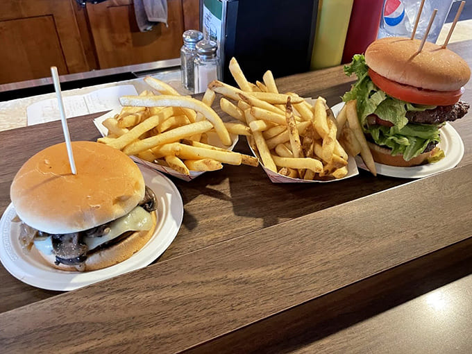 Golden fries and perfect burgers spread across the table like a delicious landscape of American comfort food dreams.