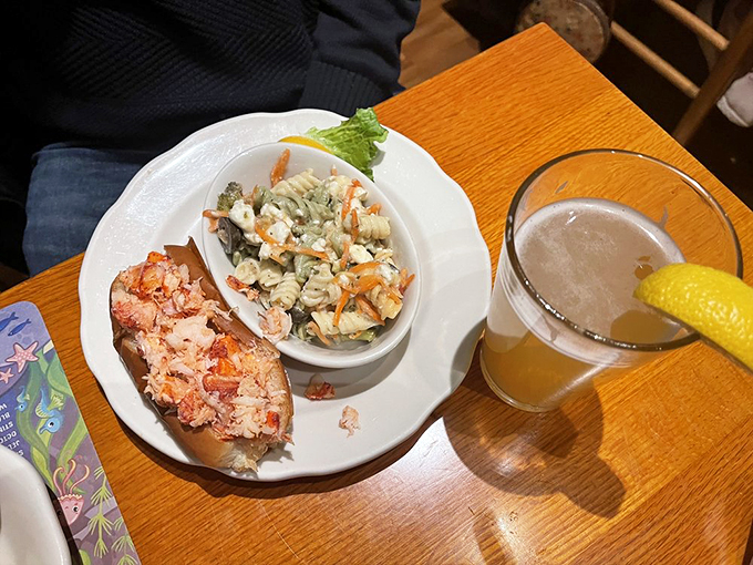 The dynamic duo of comfort food: a lobster roll that's all glitz and glamour, paired with a pasta salad that's like a hug from your grandma.