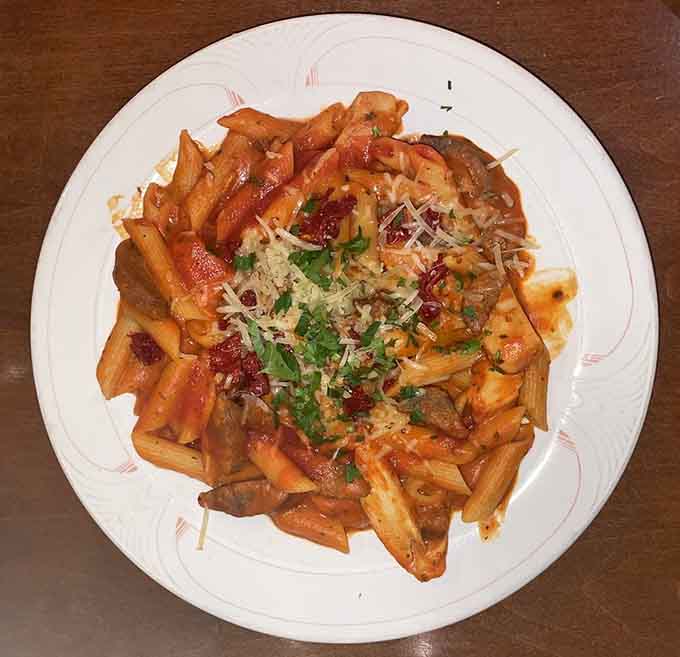 Chicken and sausage unite over linguine in a creamy tomato embrace that defines comfort food at its finest.