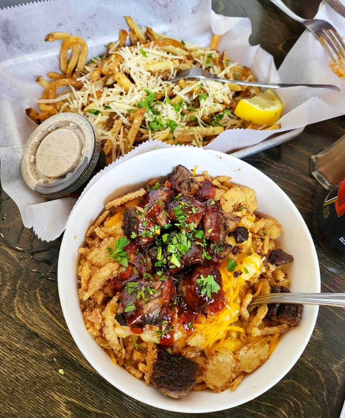 Comfort food elevated &ndash; hand-cut fries dusted with parmesan alongside a bowl of decadent mac and cheese topped with brisket.