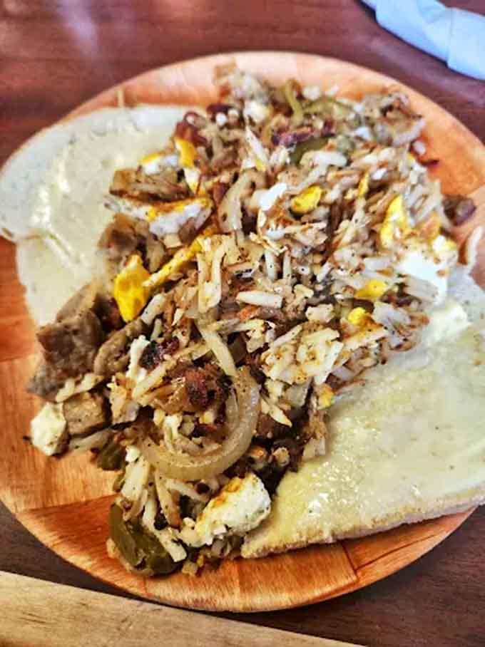 A mountain of flavor awaits in this hearty plate where shredded beef mingles with scrambled eggs, peppers, and onions &ndash; breakfast and lunch having their best conversation.