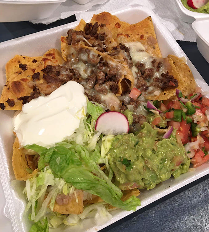 These nachos are engineered for maximum structural integrity, loaded with toppings that would make lesser chips crumble under the delicious pressure.