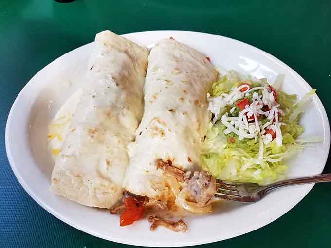 The Burrito Michoacano sits there looking innocent until you realize it's basically a warm, delicious hug wrapped in a tortilla and topped with cheese.