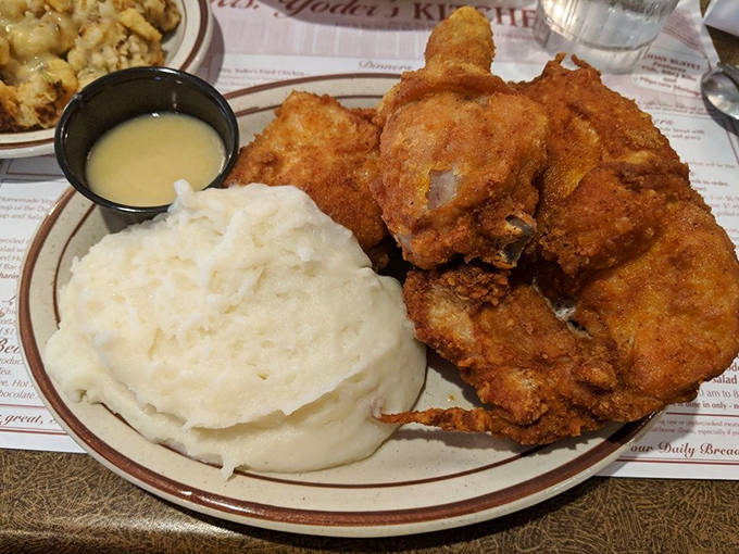 Mrs. Yoder's famous fried chicken sits beside a generous portion of those legendary mashed potatoes, a pairing that has launched a thousand food pilgrimages.