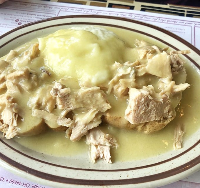 Roast turkey swimming in gravy like it's training for the Olympics, with mashed potatoes providing moral support from the sidelines.