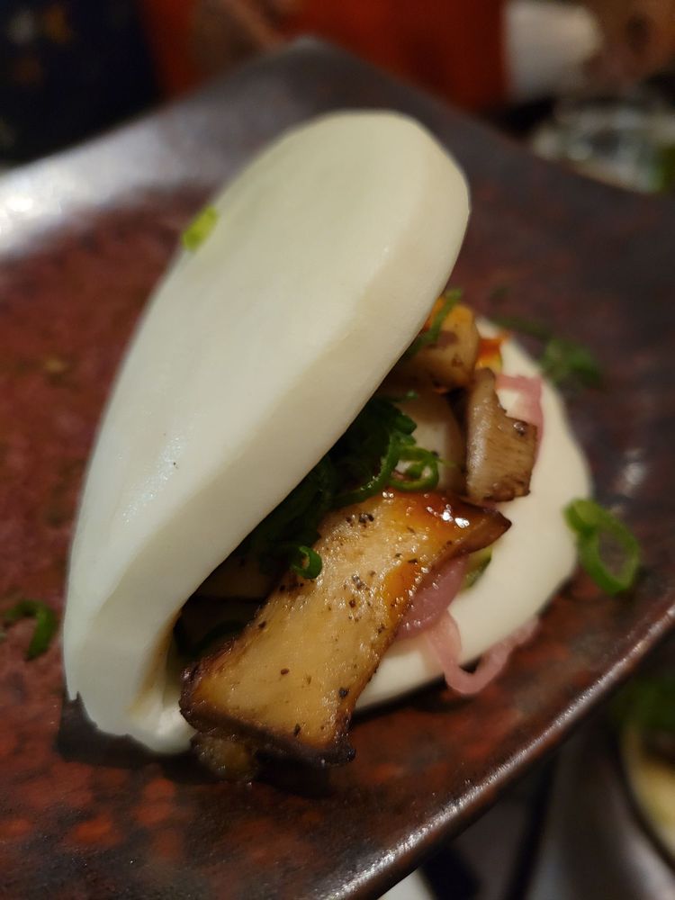 Pillowy soft bao cradles savory mushrooms and crisp vegetables – a cloud sandwich that proves vegetarian options needn't be an afterthought.