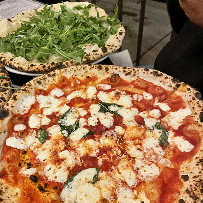 The arugula's peppery bite perfectly balances the richness of the cheese on this pizza &ndash; a thoughtful composition that elevates every ingredient.