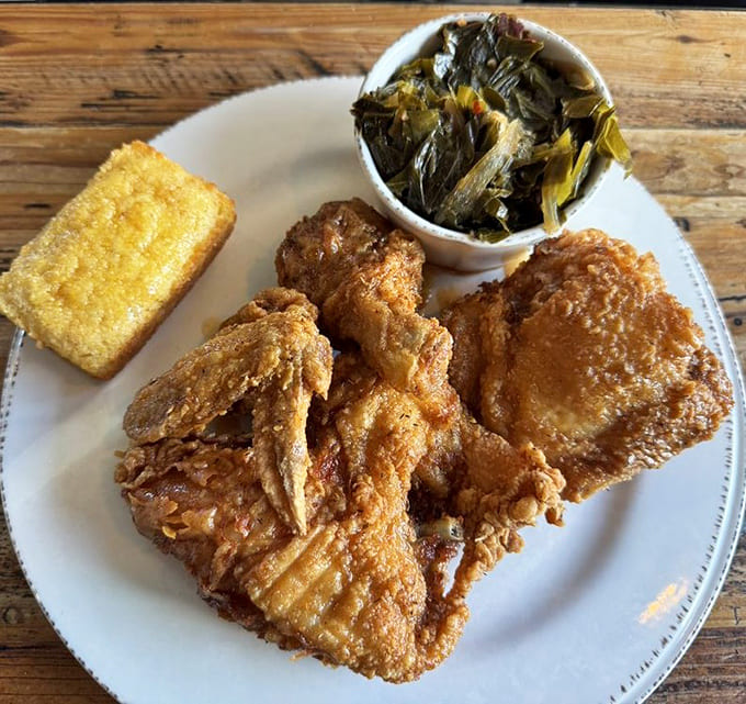 Golden fried chicken with collard greens and cornbread: the holy trinity of Southern comfort food.