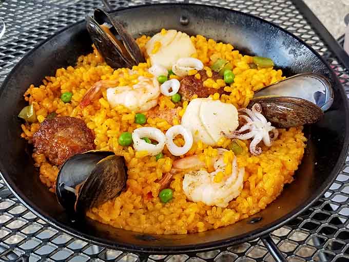 Seafood paella loaded with shrimp, mussels, and saffron-infused rice brings a taste of coastal Spain to the banks of the Mississippi River.