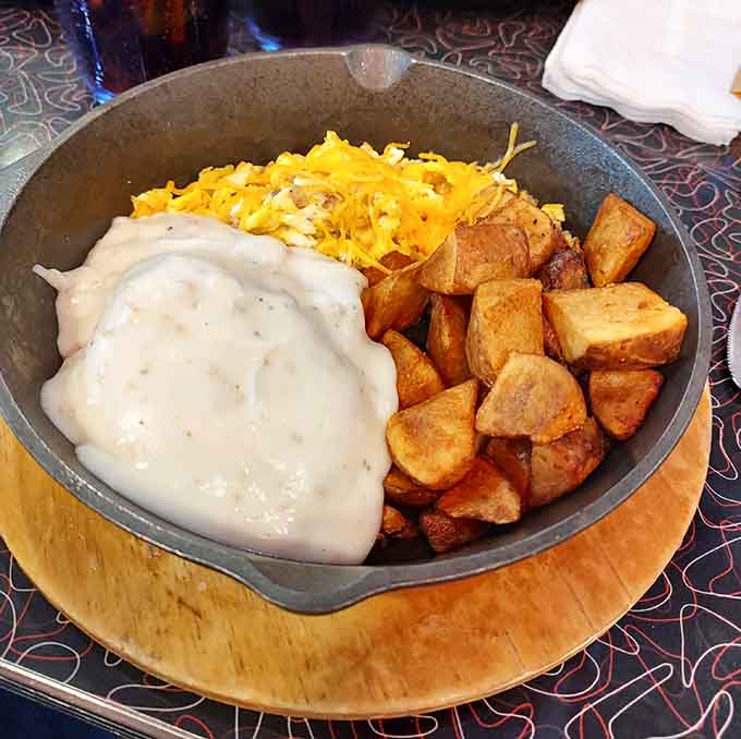 The breakfast skillet arrives like a cast-iron treasure chest filled with eggs, potatoes, and pure morning happiness.