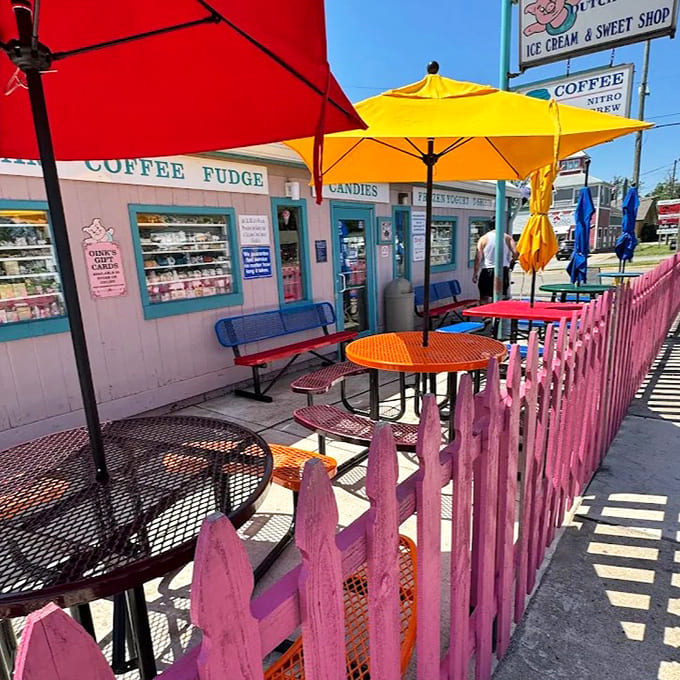 The rainbow of picnic tables behind that cheerful pink fence creates an al fresco ice cream sanctuary where calories don't dare intrude.
