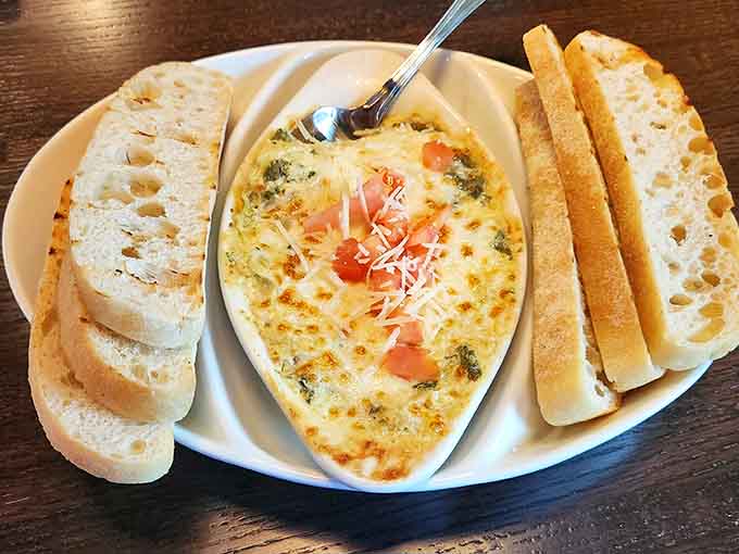 Artichoke dip comes out golden and bubbly, surrounded by bread that exists solely to transport this creamy goodness to your mouth.