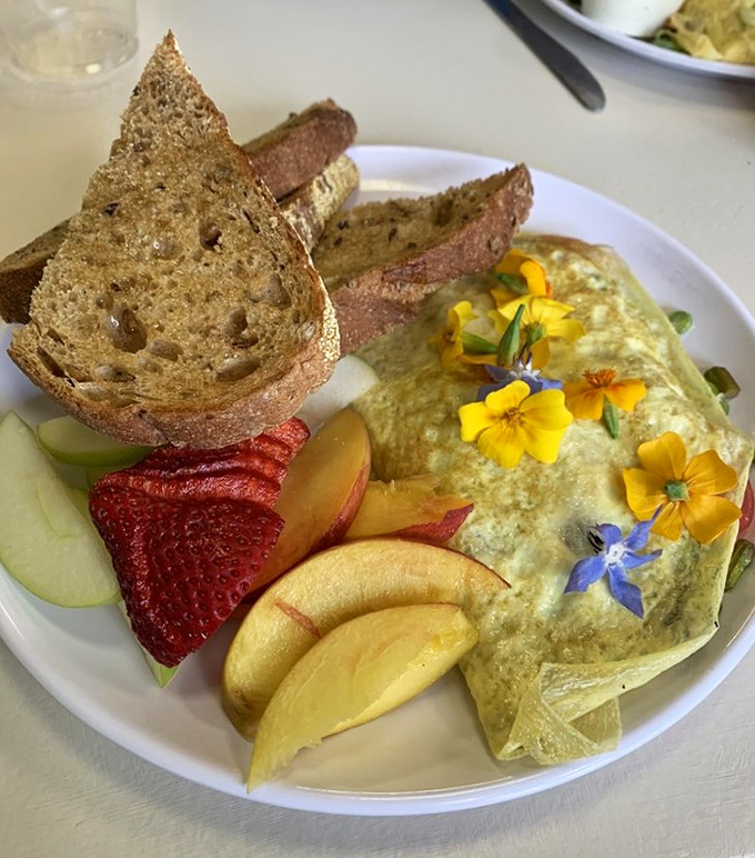 Edible flowers transform this omelet from mere breakfast to Instagram-worthy art that almost feels too pretty to eat. Almost.