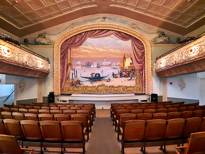 Opera House: Velvet curtains frame a stage where performers entertain an international audience, the painted backdrop transporting viewers to distant Venetian canals.