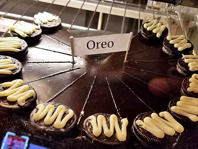 Oreo cookies stand at attention around this chocolate masterpiece, like delicious sentries guarding a treasure of cream and cake.