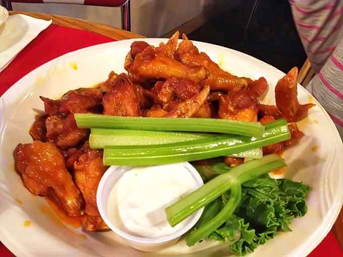 The original buffalo wings glisten with that classic sauce that made this style famous, striking that perfect balance between tangy and spicy that keeps you coming back.