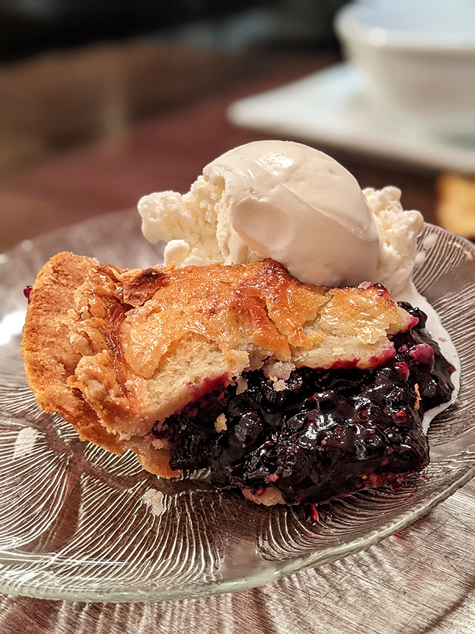 Wild Maine blueberries burst beneath a golden crust, the perfect sweet finale to a meal that celebrates local flavors.