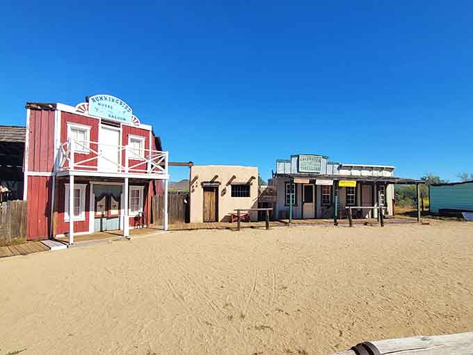 Wooden storefronts line the dusty street, creating an authentic Western town atmosphere that makes you half expect a tumbleweed to roll past.
