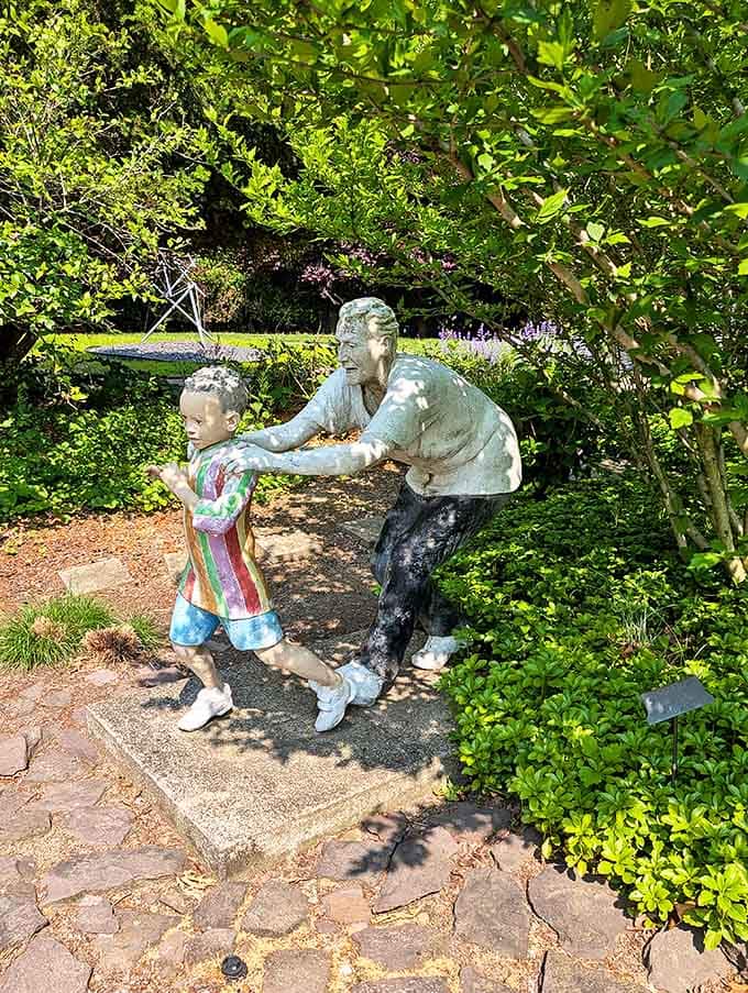 Frozen in mid-motion, these figures capture the universal joy of play across generations, their metallic forms radiating warmth.