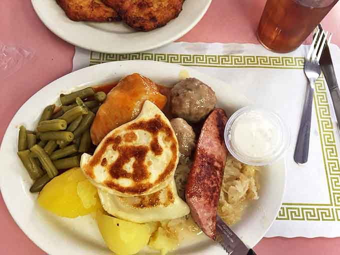 A Polish feast fit for royalty: cabbage rolls, kielbasa, and potatoes sharing plate space in perfect harmony.