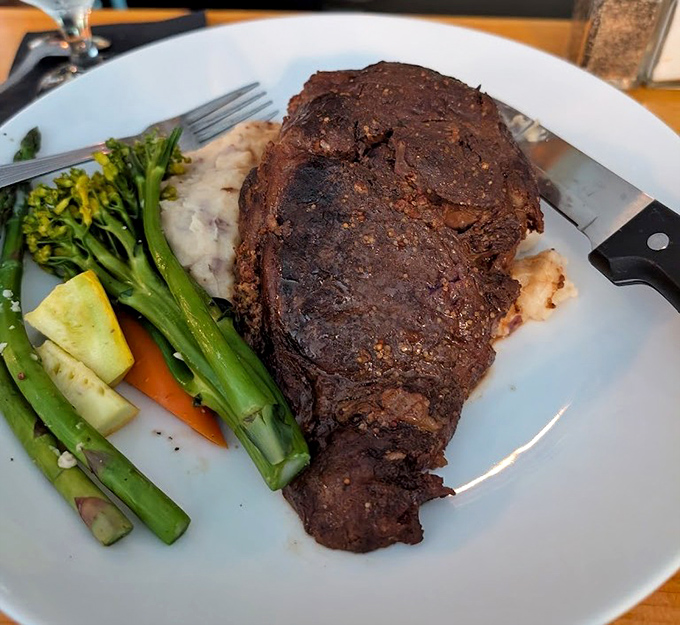 Herb-crusted perfection alongside seasonal vegetables and creamy mashed potatoes &ndash; carnivore heaven that would make any steakhouse jealous.