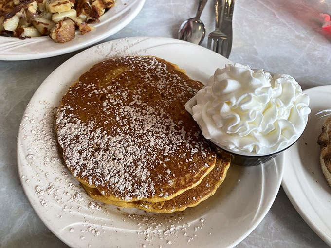 Pumpkin pancakes arrive like autumn on a plate, complete with whipped cream and the kind of spices that make you want a flannel shirt.