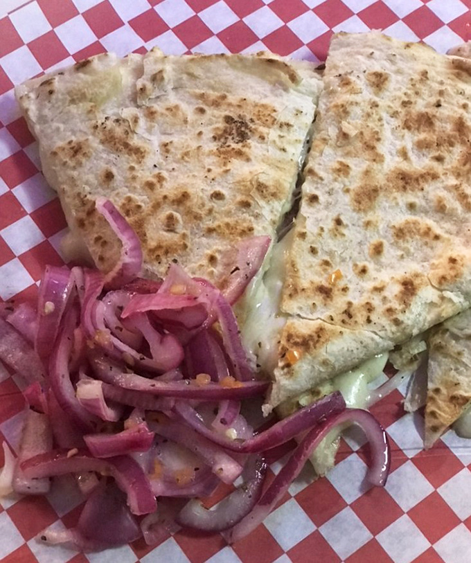 This quesadilla isn't just melted cheese between tortillas, it's a golden-brown envelope delivering a message of pure joy to your taste buds.