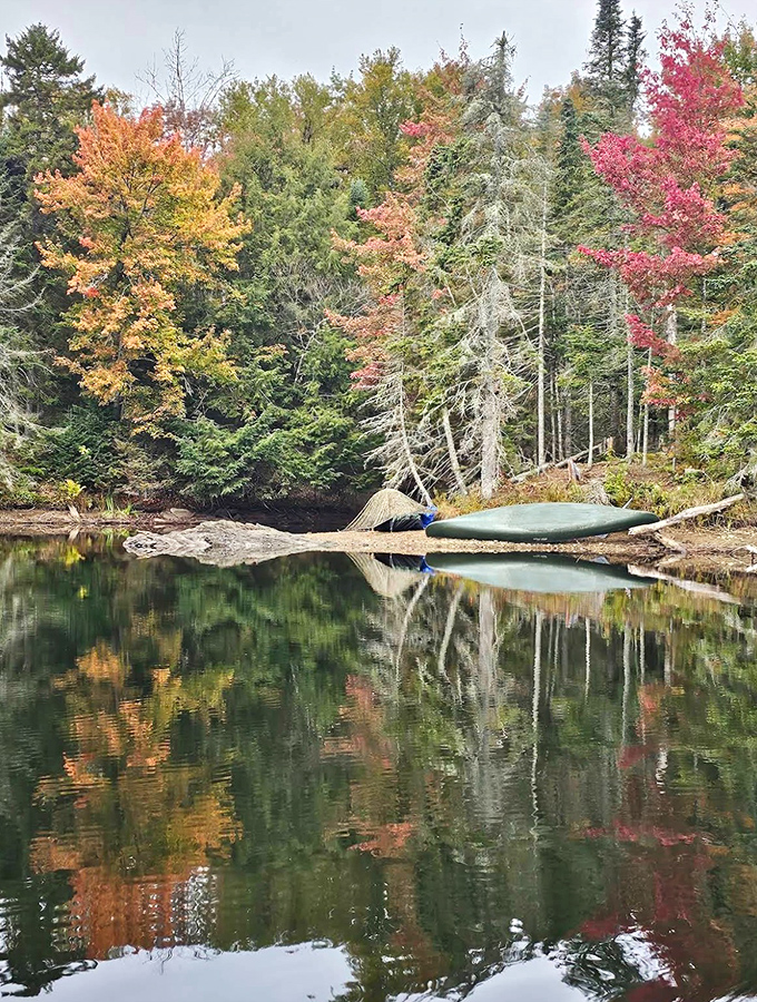 Fall foliage creates a perfect frame around the glass-like reservoir, where every tree and cloud gets a second life in the water's mirror.